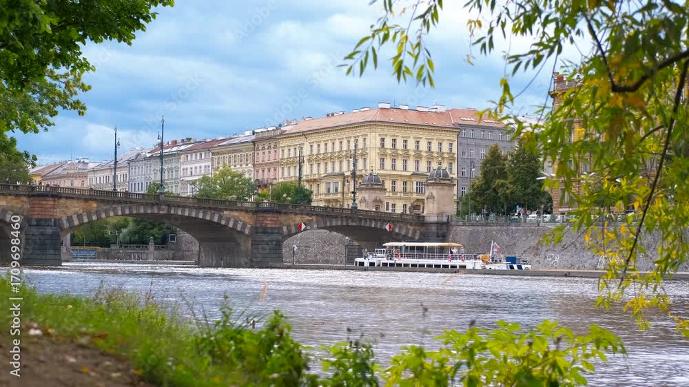 Passenger ferry navigating vltava river under legion bridge in prague ...