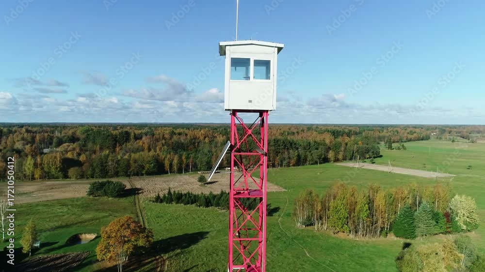 Drone cinematic orbit fire watch tower Rucava Latvia with solar powered ...