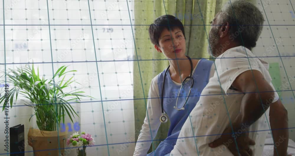 Patient entering gripping lower back in clinic and nurse leaning ...