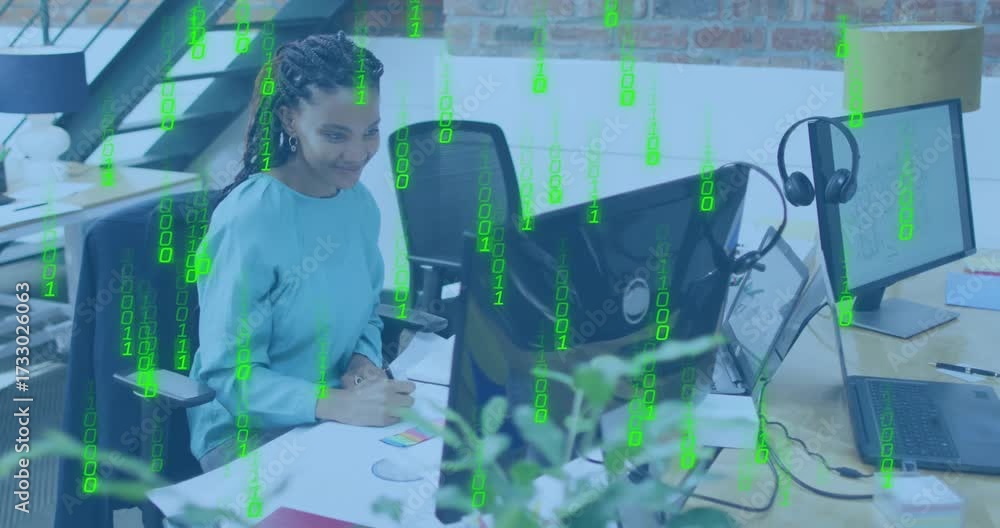 graphic designer woman at desk initiating code overlay as typing ...
