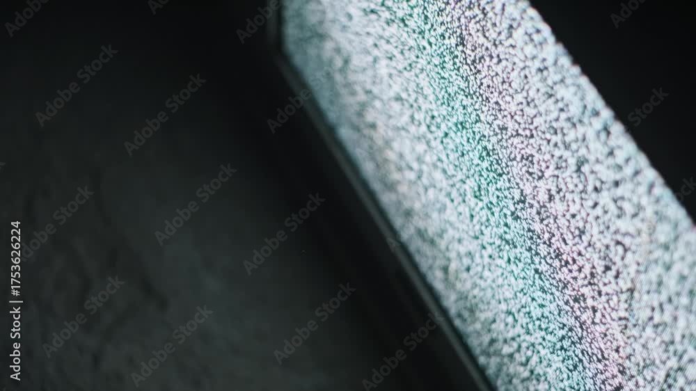 Angled macro perspective focuses on the flickering distortion of static ...