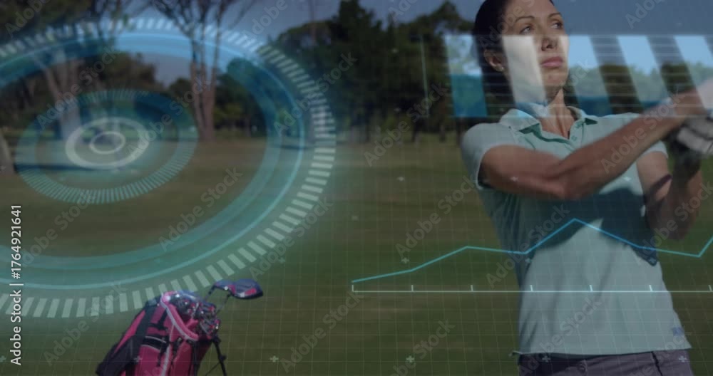 Golfer lifting driver into backswing, finishing swing with rings ...