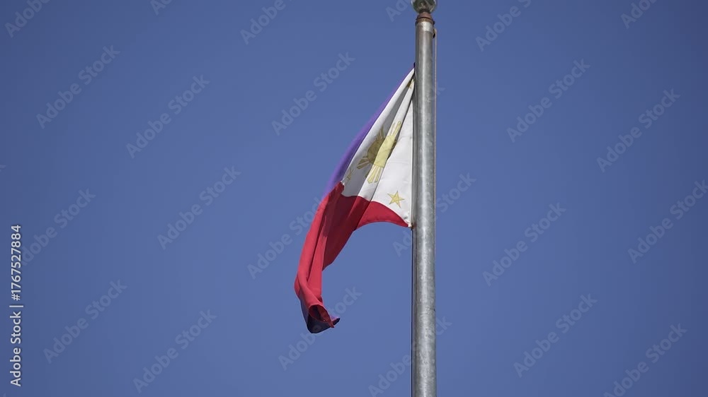 Majestic Philippine flag waving proudly against the clear blue sky ...
