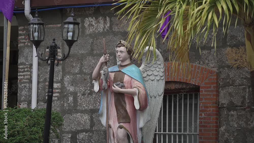 Vídeo do Stock: Statue of Archangel Raphael holding a fish and staff ...