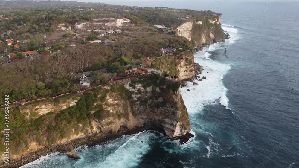 An ultra-wide 4K drone shot captures the immense Uluwatu cliffside in ...