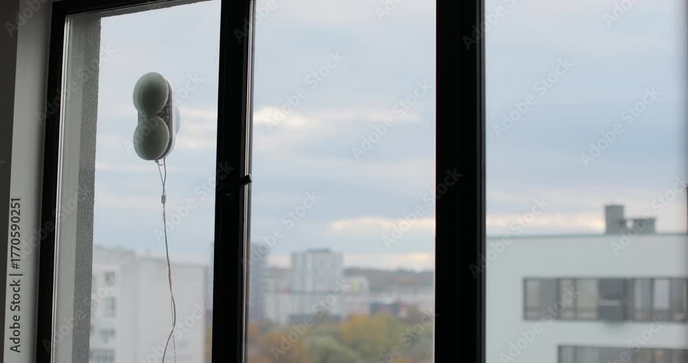Washing of panoramic windows. Window cleaning robot. The assistant ...
