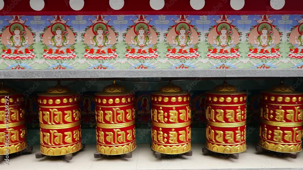 Rotating brass prayer wheels in Nepal monastery. Buddhist symbols ...