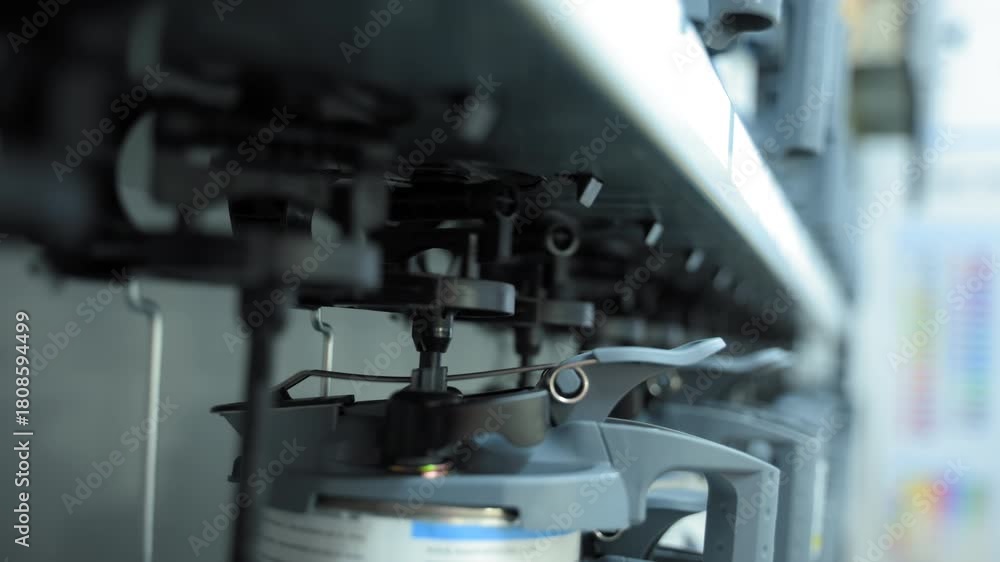 Close-up view of an industrial paint mixing machine. Mechanical arms ...