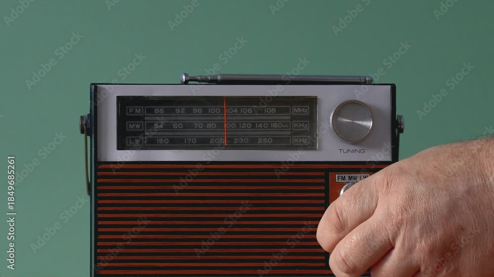 Listening to old radio while fine-tuning stations at home in simple ...