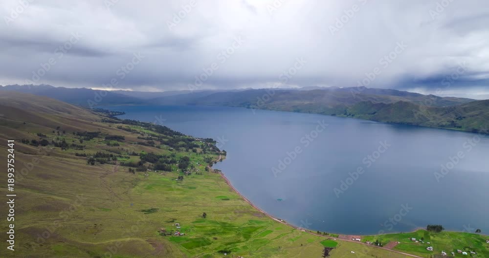 Aerial establishing of Laguna Langui surrounded by high Andean plains ...