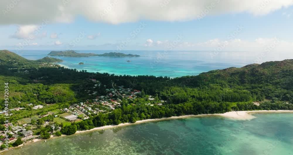 Overlooking a coastal village, lush greenery, blue waters, and distant ...