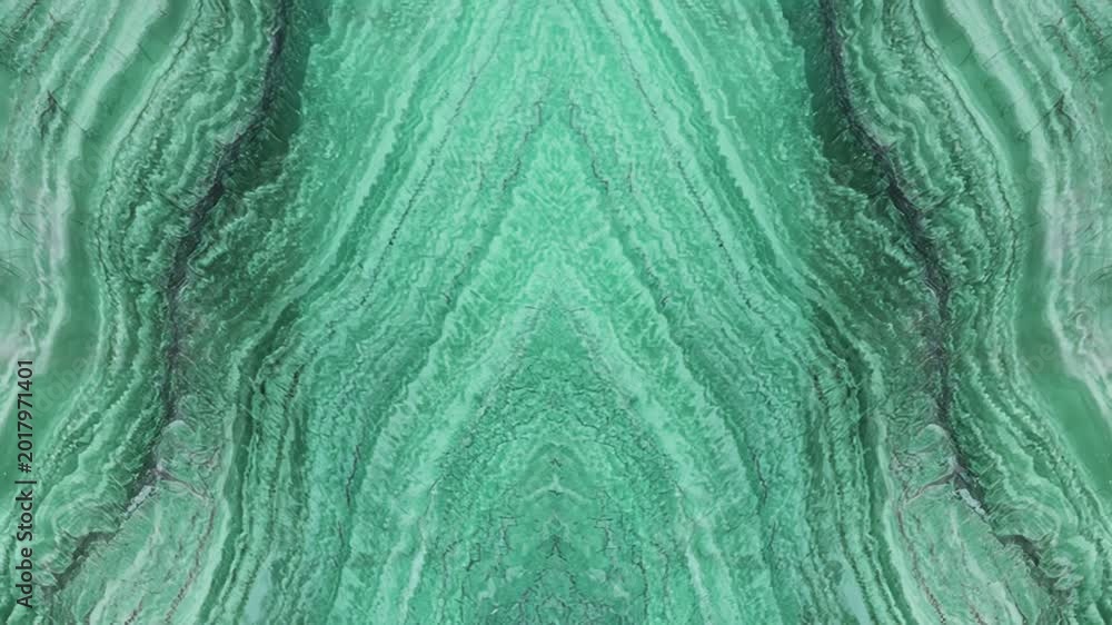 Bright green malachite stone texture with symmetrical wave patterns and ...