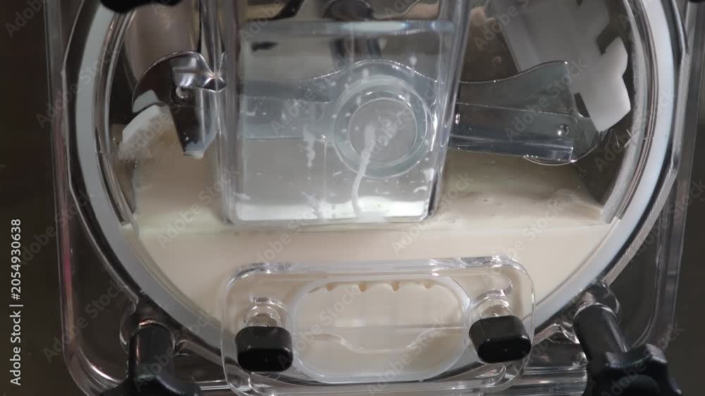ice cream coming out of the ice cream maker. freshly made homemade ice ...