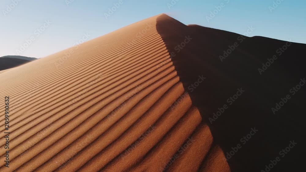 Ripple Sand dune in sossusvlei, namib desert, against a clear blue sky ...