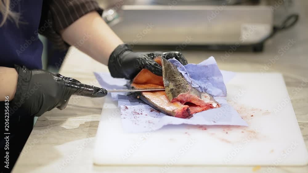 Cutting red fish with a knife at a master class. Very soft focus Stock ...
